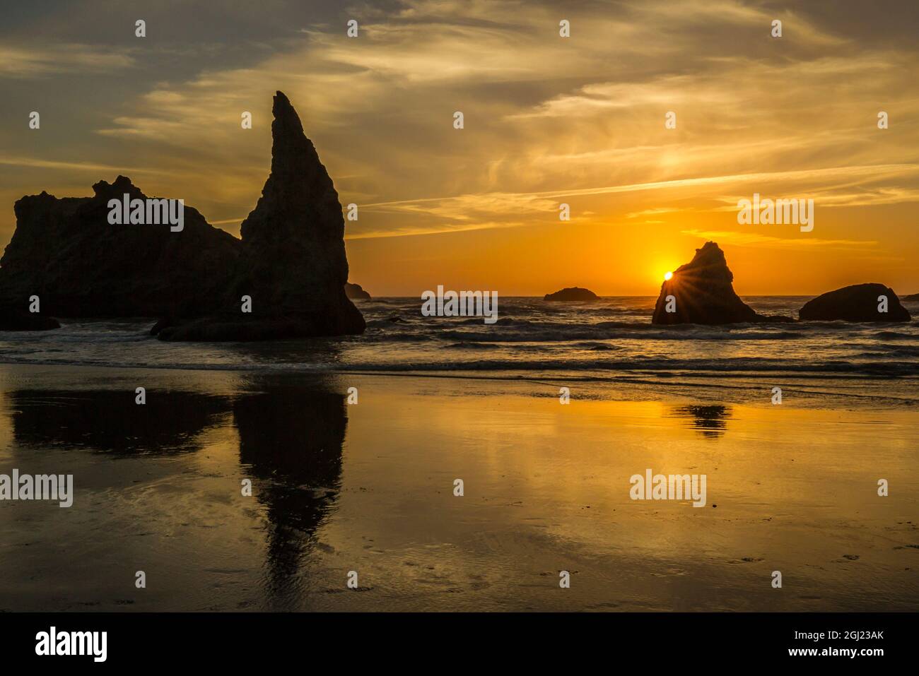USA, Oregon, Bandon Beach, Wizard's Hat, sunset, sun star Stock Photo ...