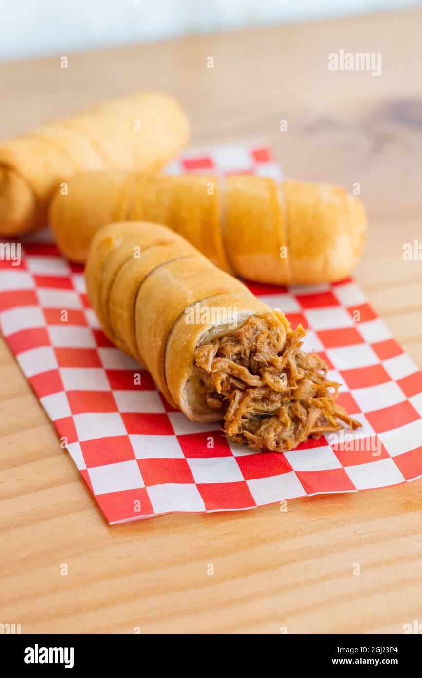 Venezuelan tequenos stuffed with pulled pork on wooden table Stock ...