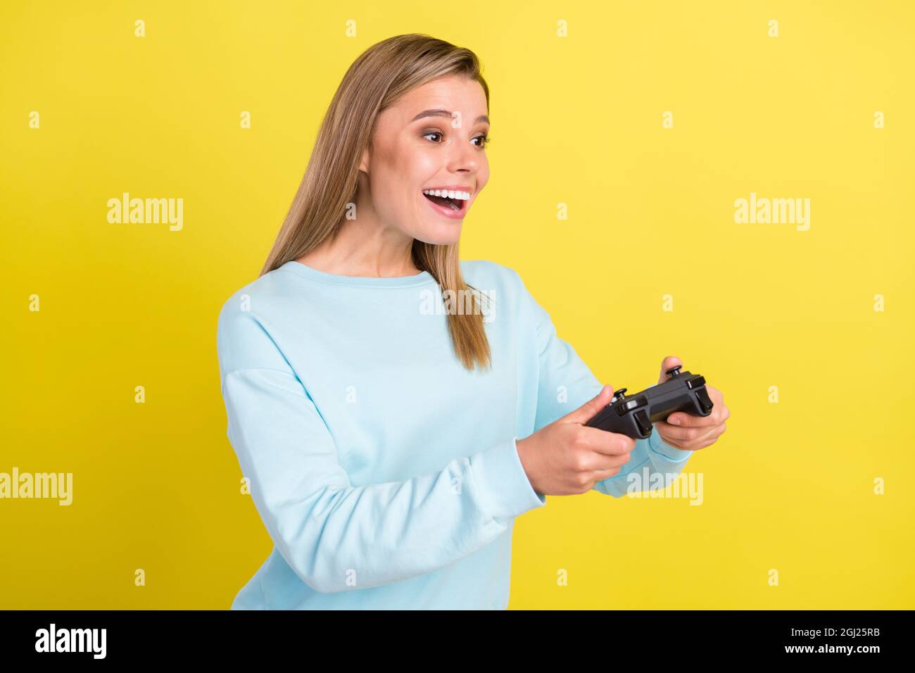 Portrait of attractive focused cheerful girl playing video game free ...
