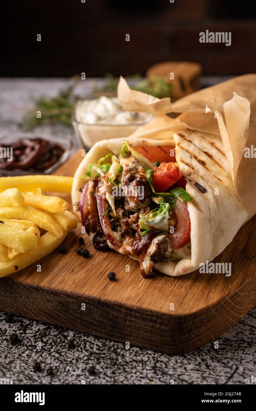 doner kebab, a shawarma in a pit of fresh vegetables and meat. with ...
