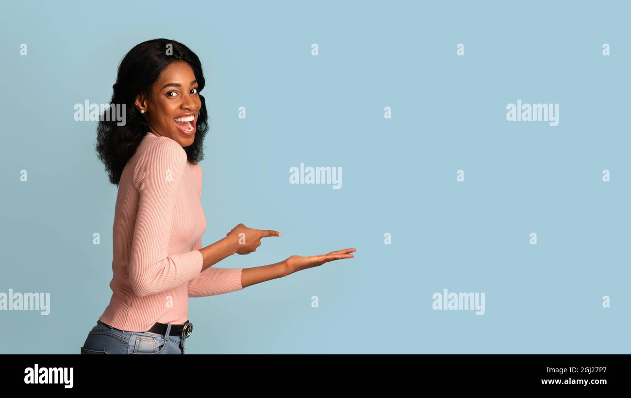 Cool Offer. Cheerful Young Black Woman Pointing At Her Open Empty Palm ...