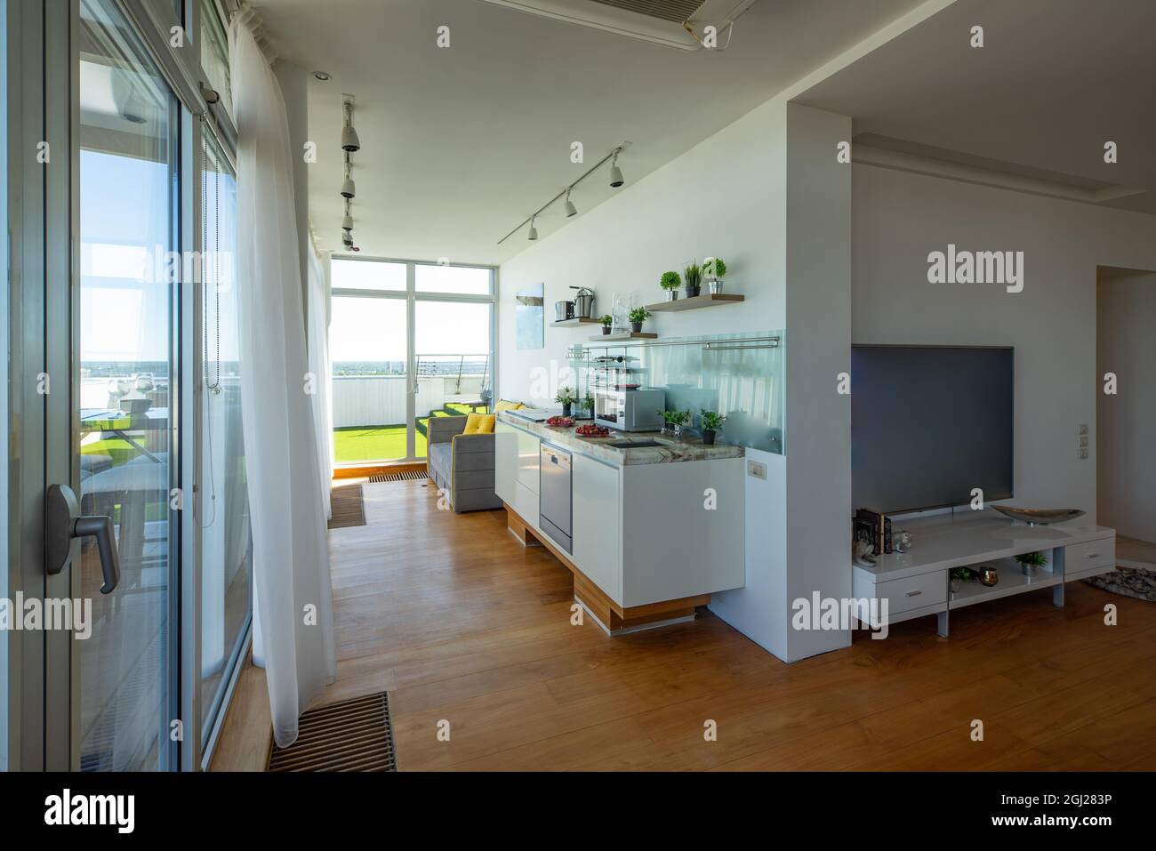 Modern kitchen interior in luxury studio apartment. Panorama windows ...