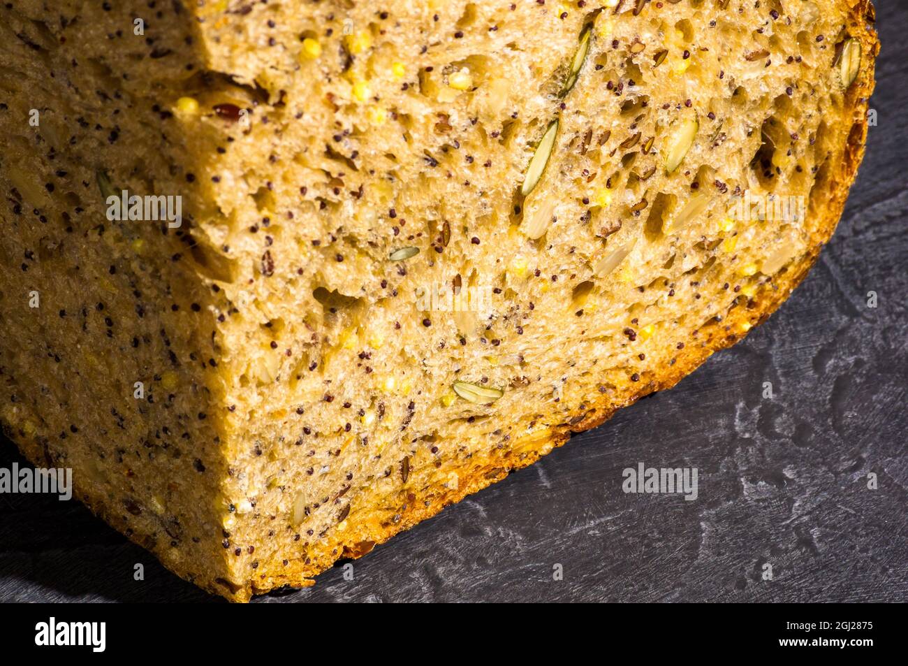 Slice of rustic natural yeast-free bread with flax, poppy seeds, sesame ...