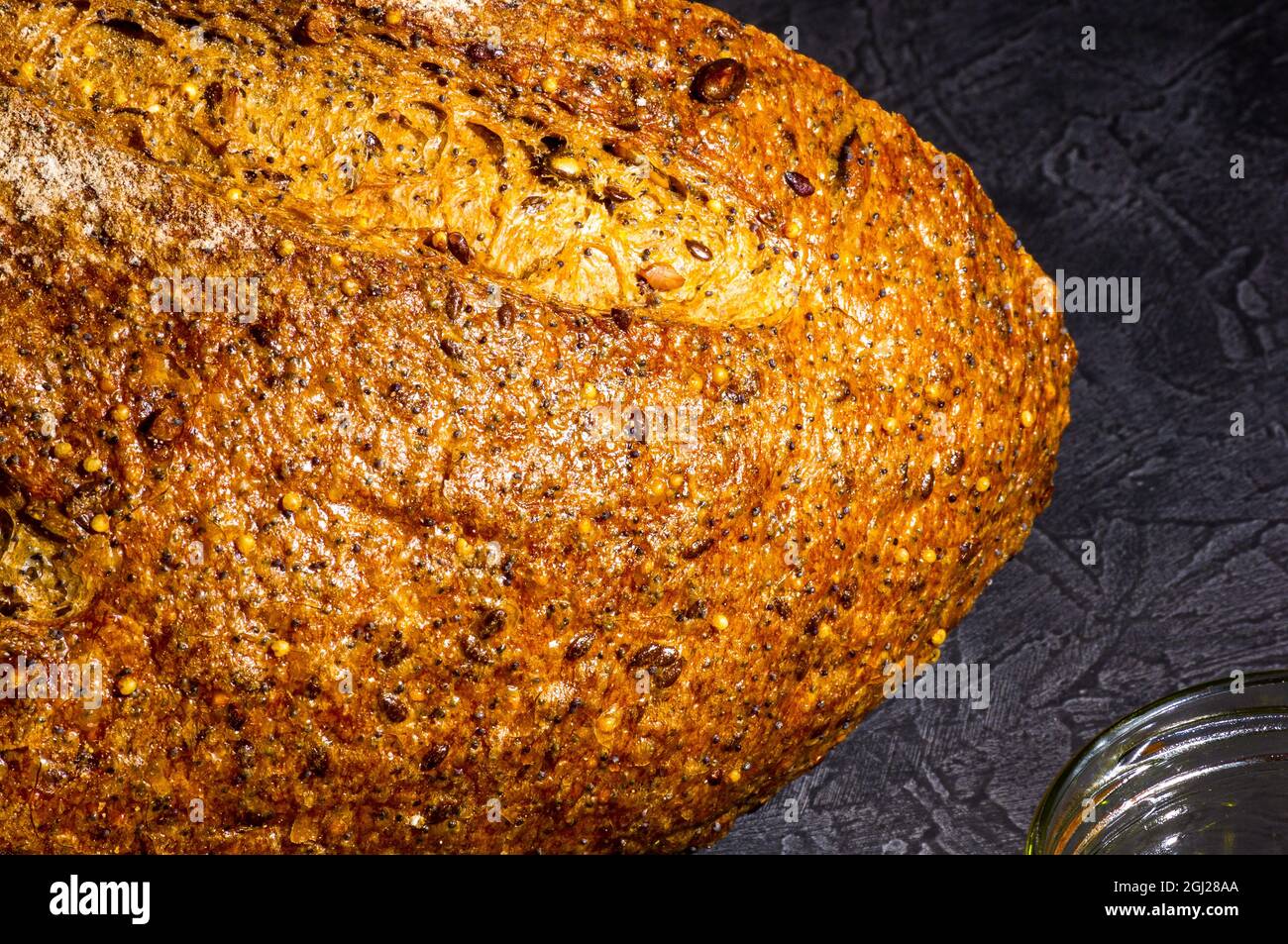Slice of rustic natural yeast-free bread with flax, poppy seeds, sesame ...