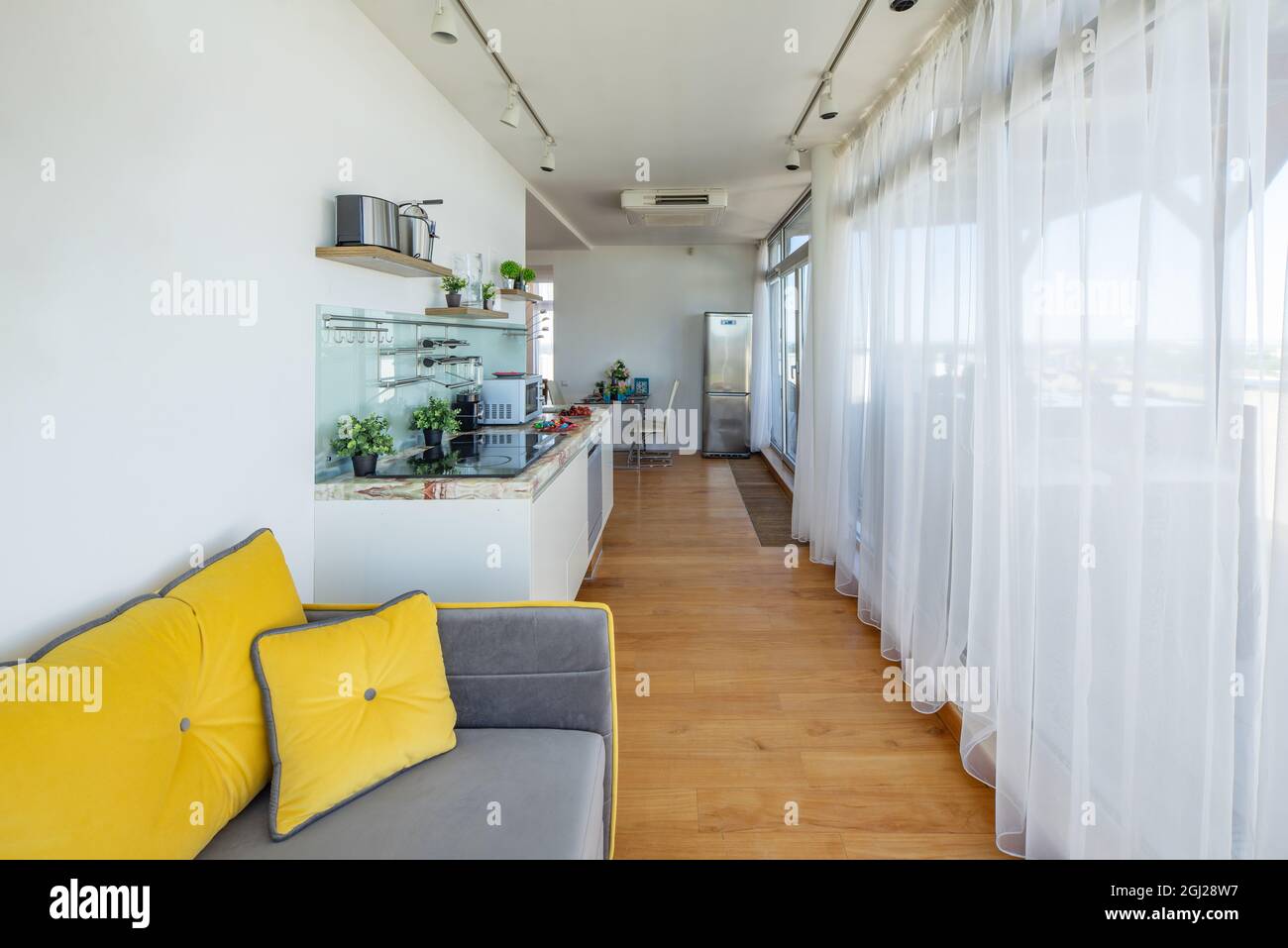 Modern kitchen interior in luxury studio apartment. Cozy sofa. Table ...