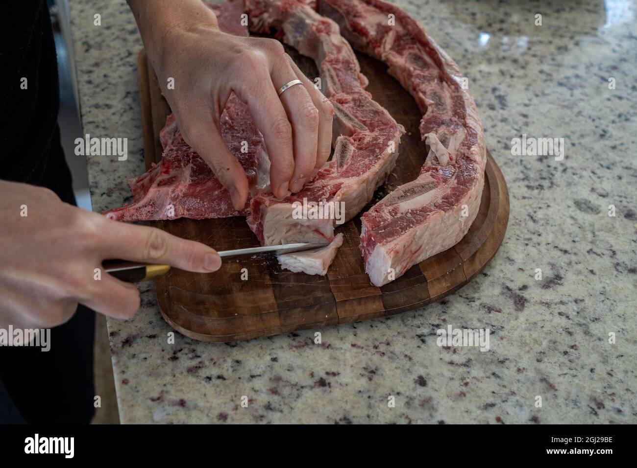 Cook preparing a typical Argentinian Asado with beef and sausage Stock ...