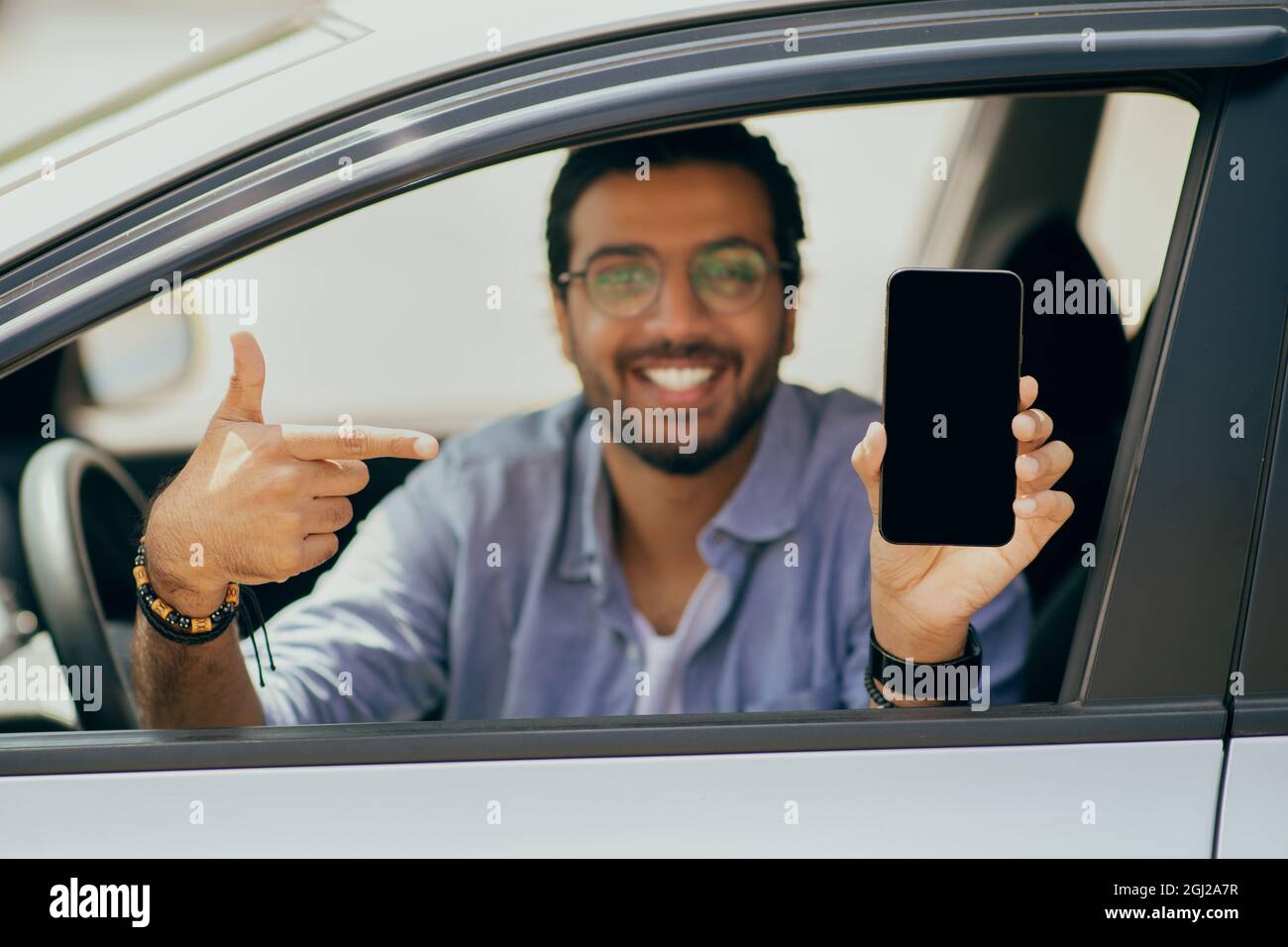 Selective focus on mobile phone with empty display in smiling middle ...