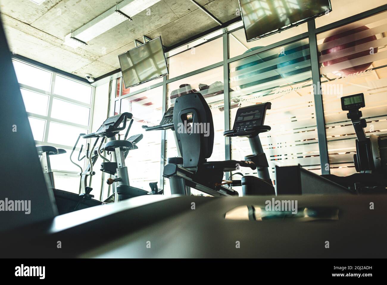 Running simulators in the gym interior opposite the window. Empty ...