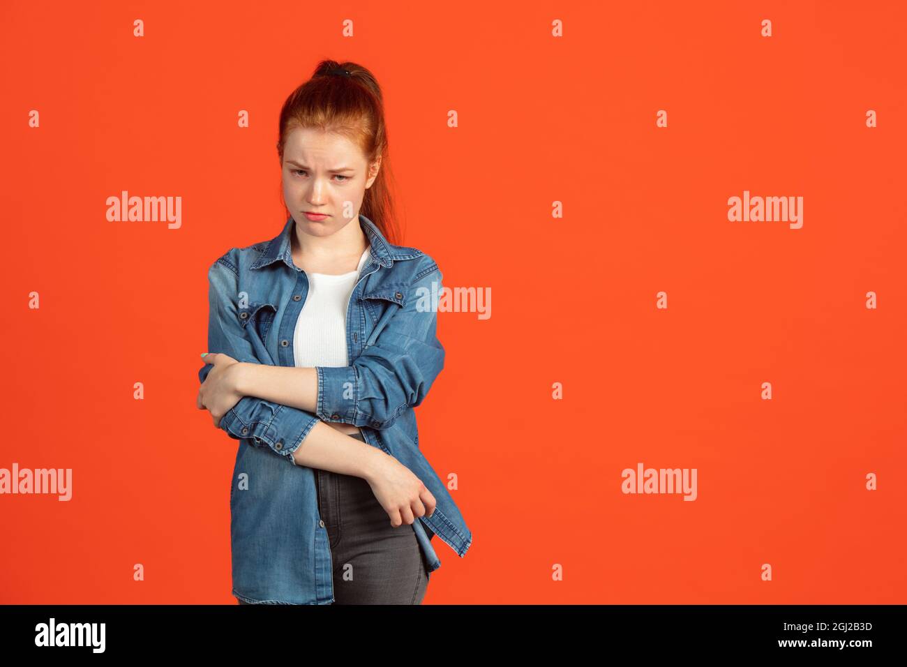 Resentful temper. Half-length portrait of young beautiful girl isolated ...
