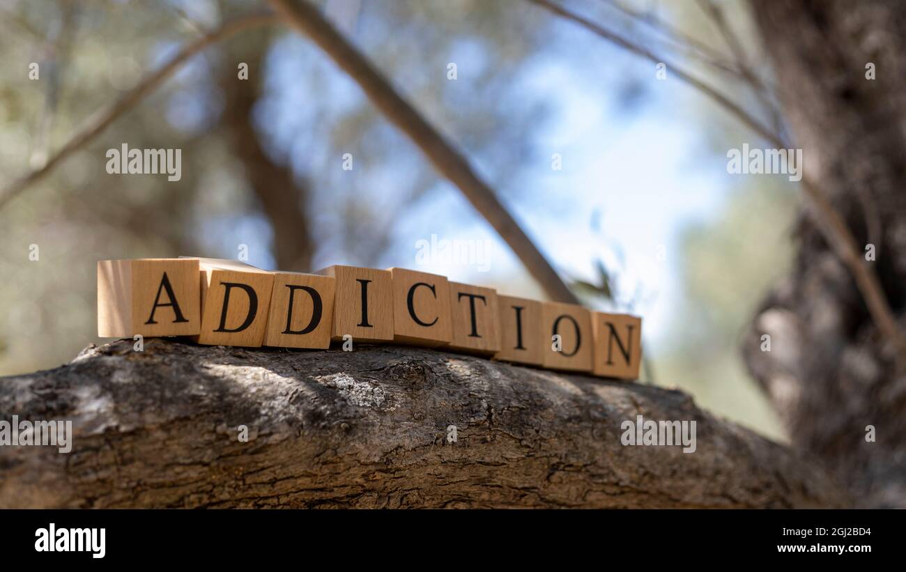 The word ADDICTION was created from wooden cubes. Taken outside on a ...