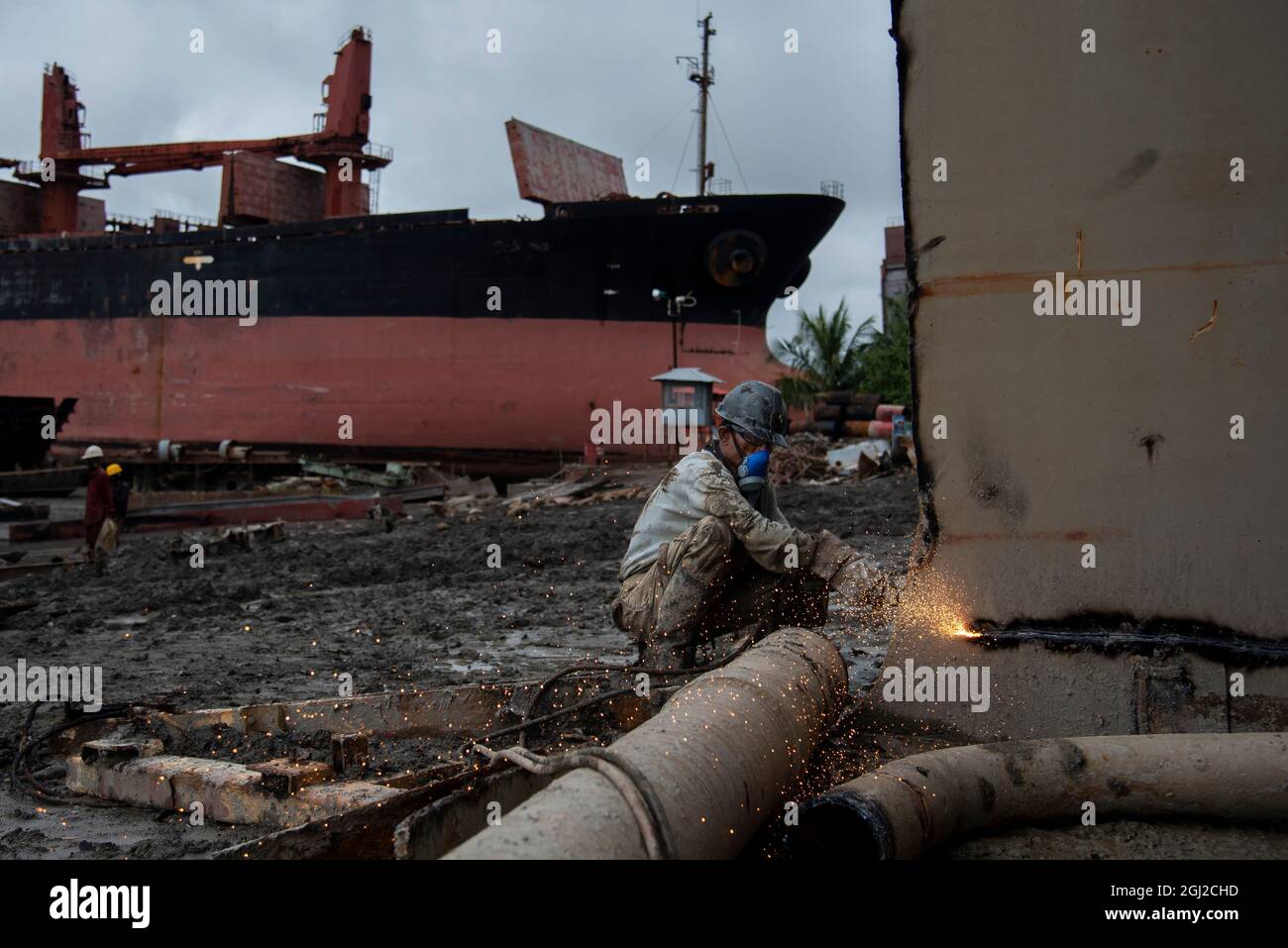 Bangladesh ship breaking yard (Chittagong). Ship recycling yard with industrial workers, heavy ...