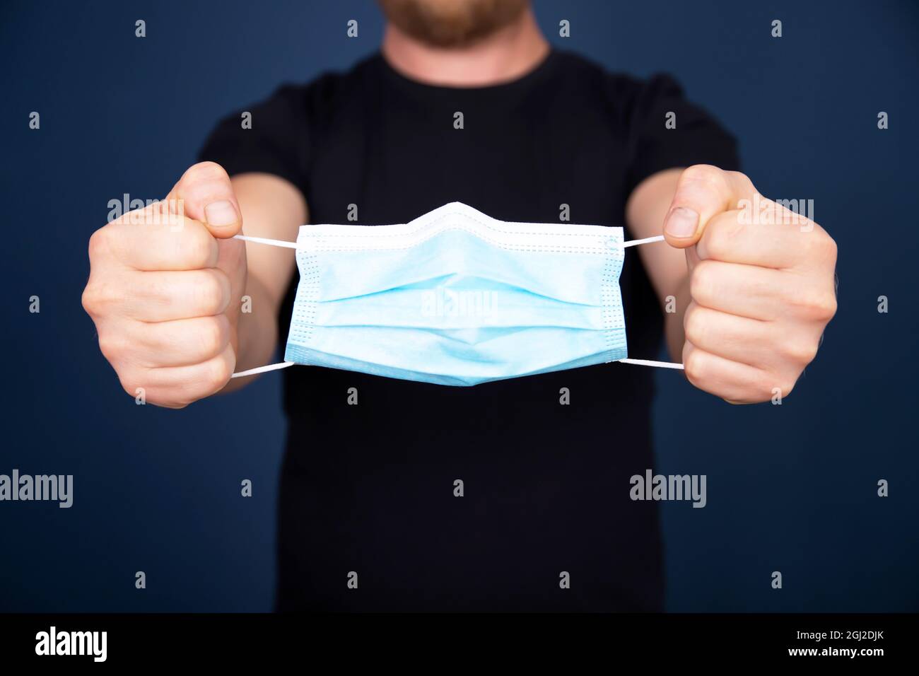 Medical mask as handcuffs on man hands Stock Photo - Alamy