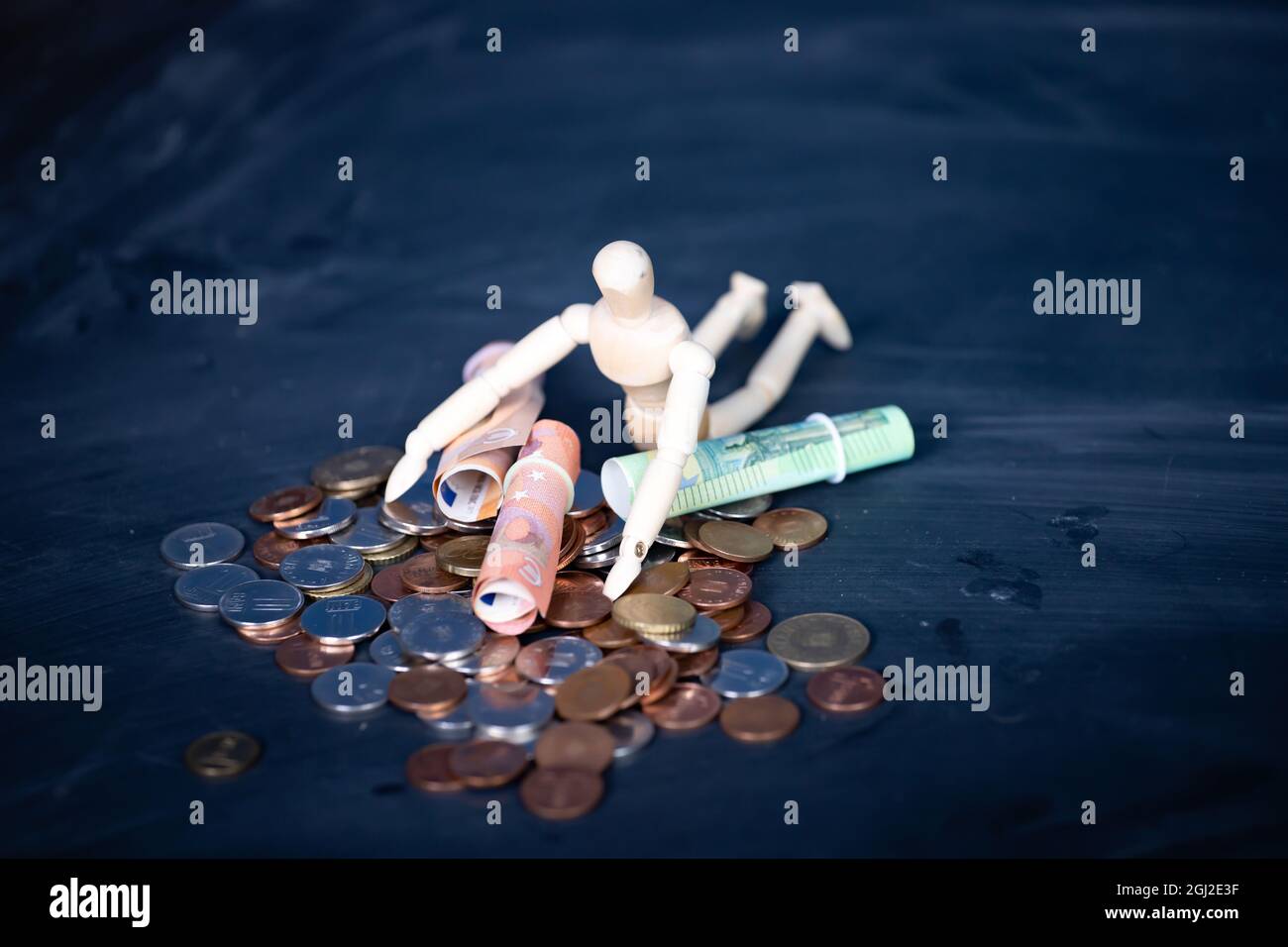 Wooden man lying on a stack of money. Business, financial concept Stock ...