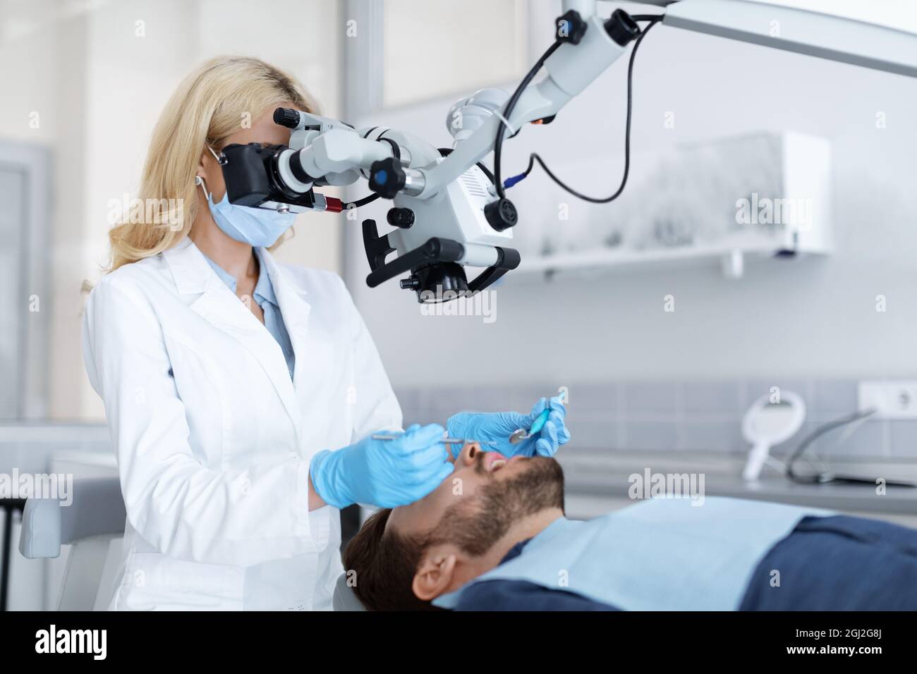 Innovative instruments in modern microdentistry. Female dentist looking ...