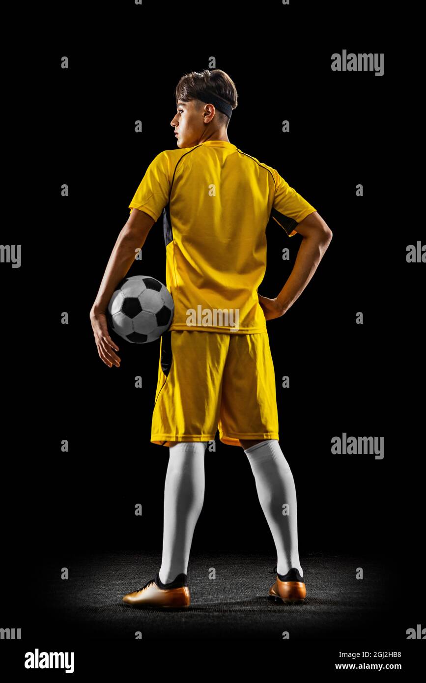 Full-length portrait of young professional football player isolated ...