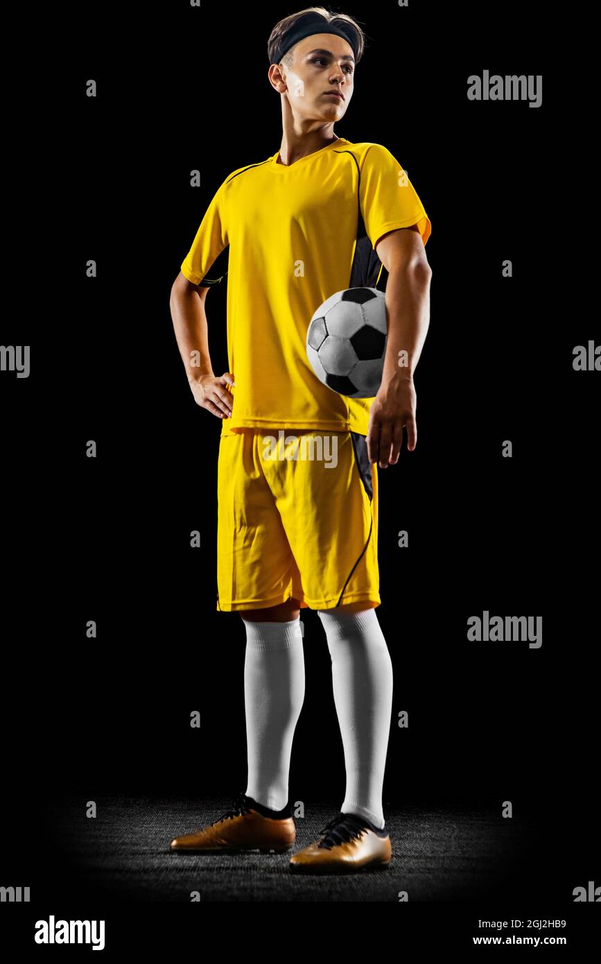 Full-length portrait of young professional football player isolated ...