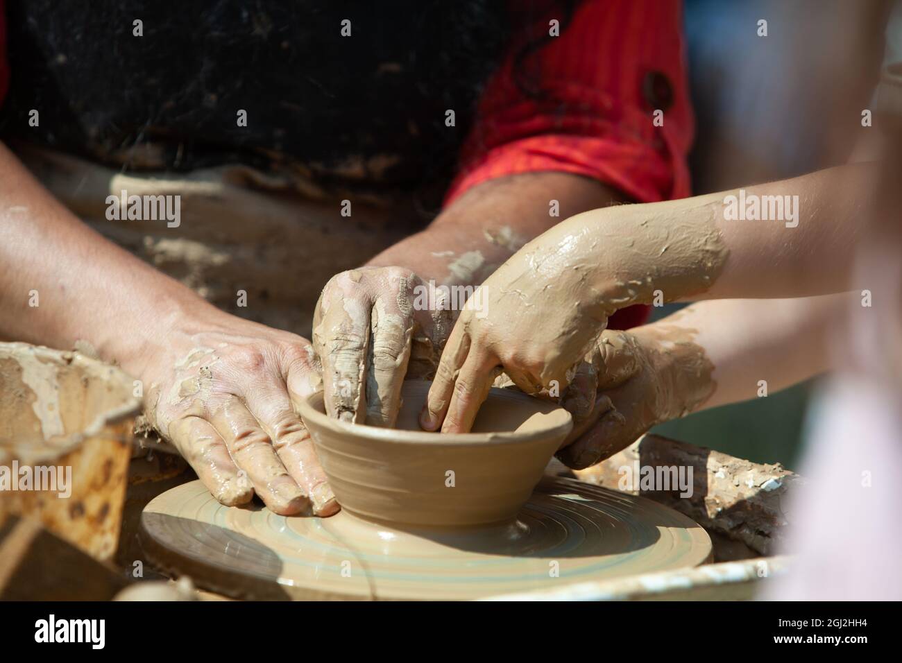 Pottery workshop. Woman teaching a child how to create a pot Stock ...