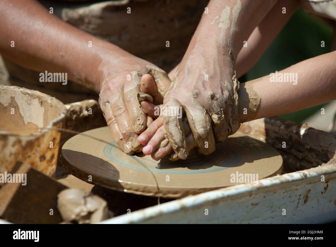 Pottery workshop. Woman teaching a child how to create a pot Stock ...