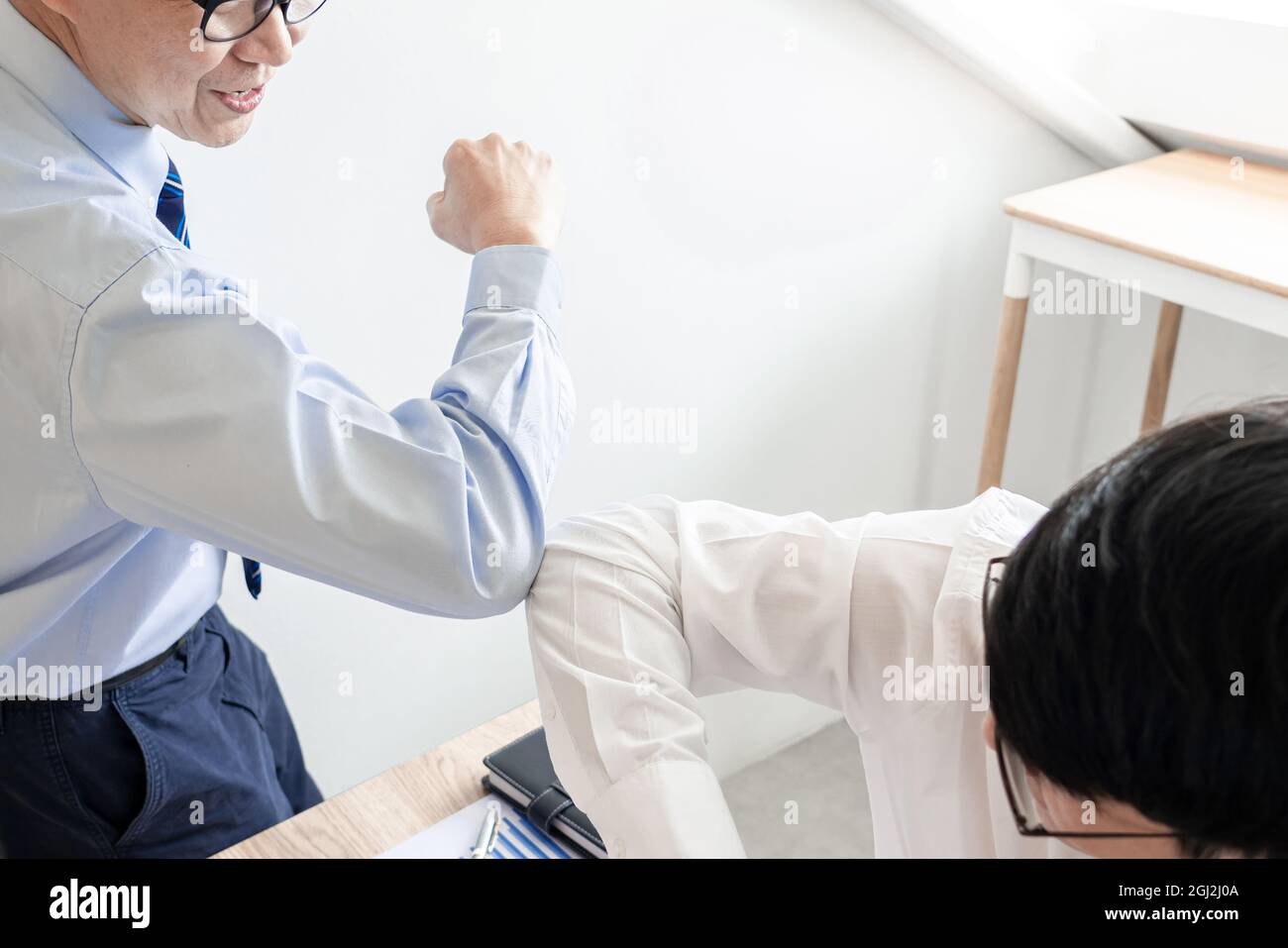 two entrepreneurs touching elbows together for the new partnership ...