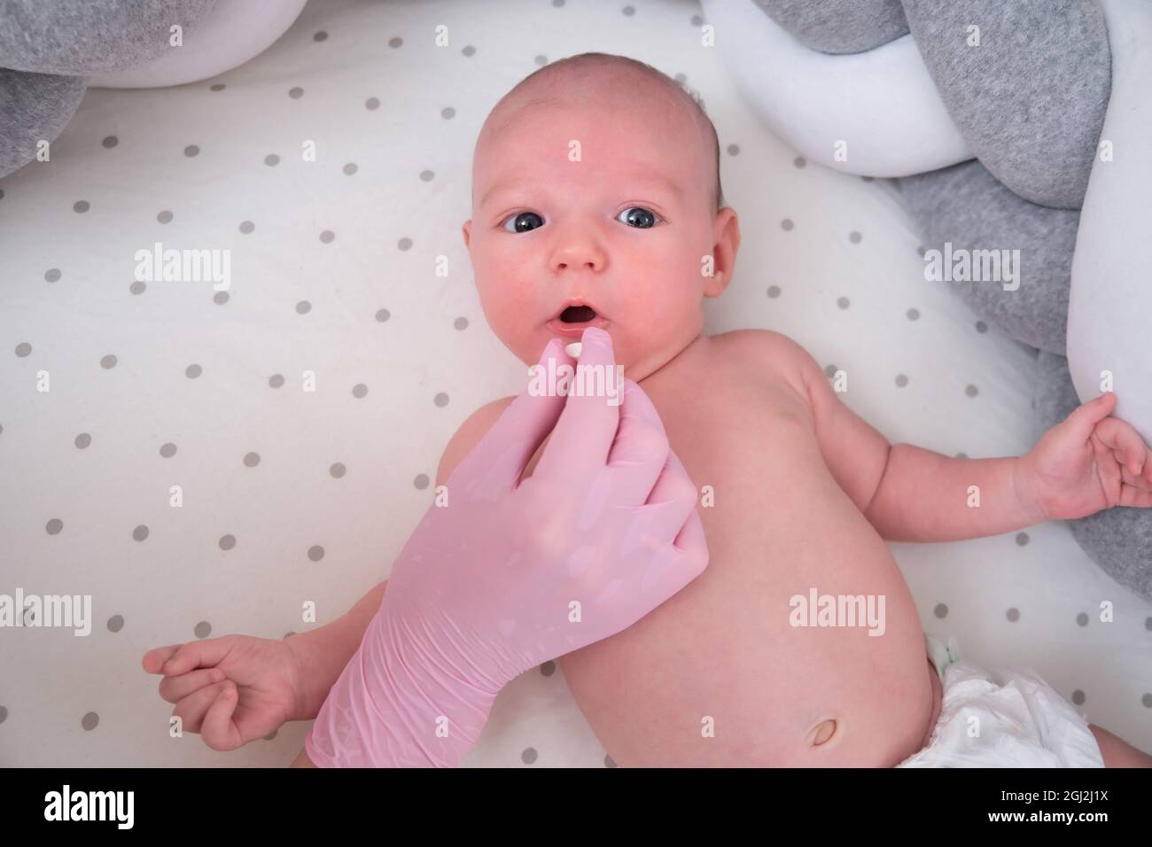 The doctor prescribes pills for a newborn child. A nurse in uniform ...