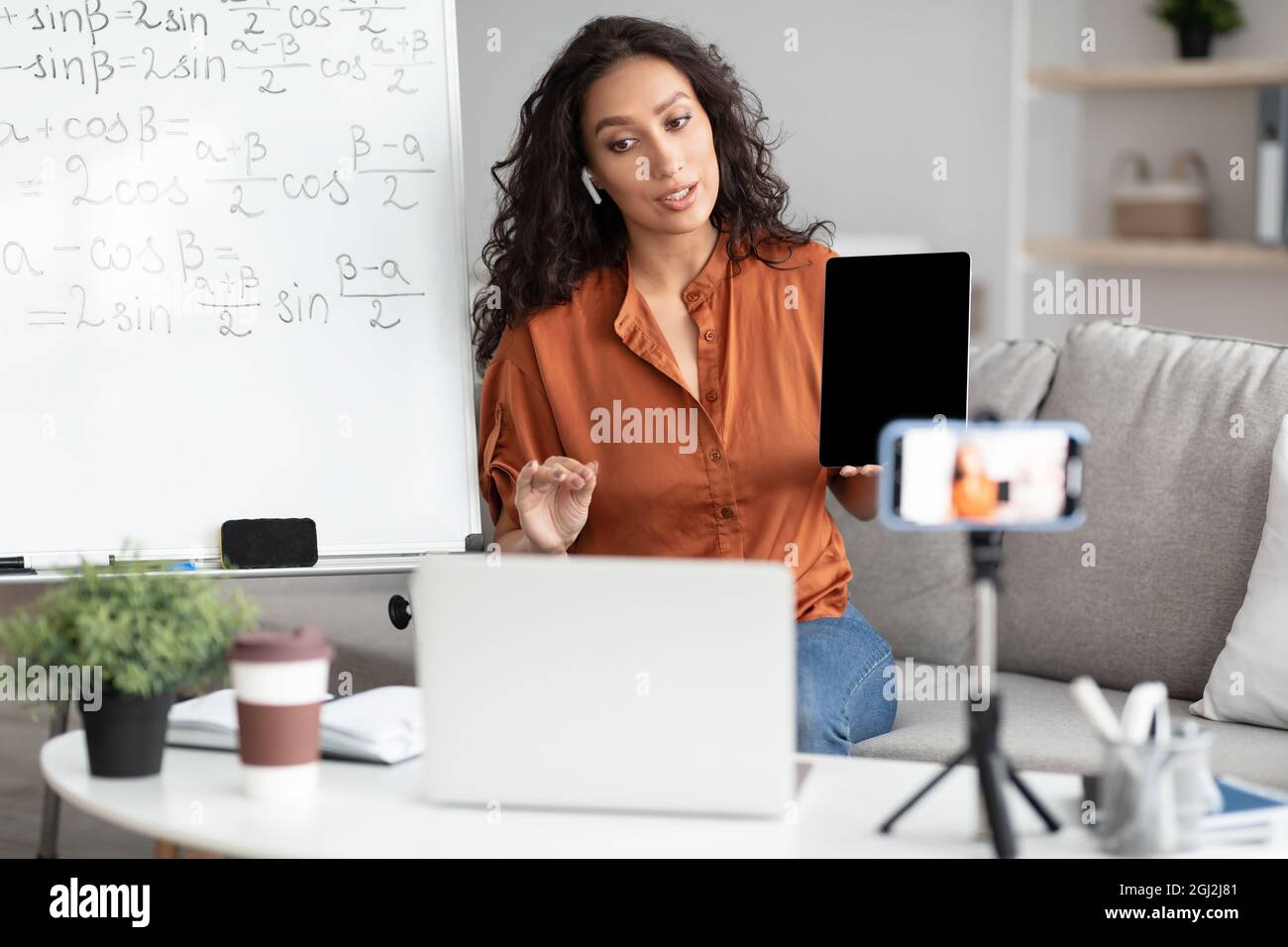 Female math teacher making video conference chat with students using ...