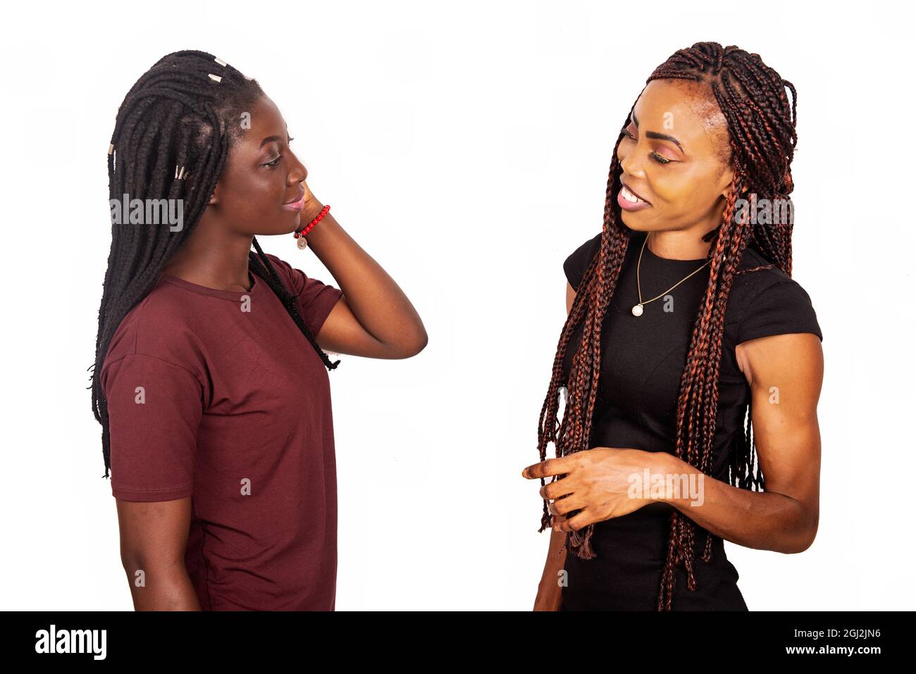 two beautiful standing students are talking together while smiling ...