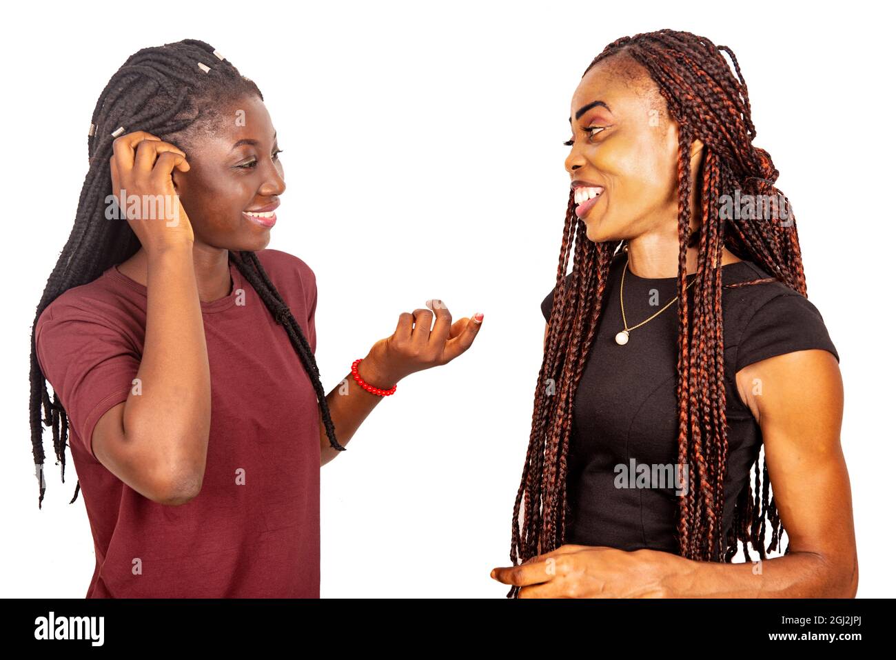 two beautiful standing students are talking together while smiling ...