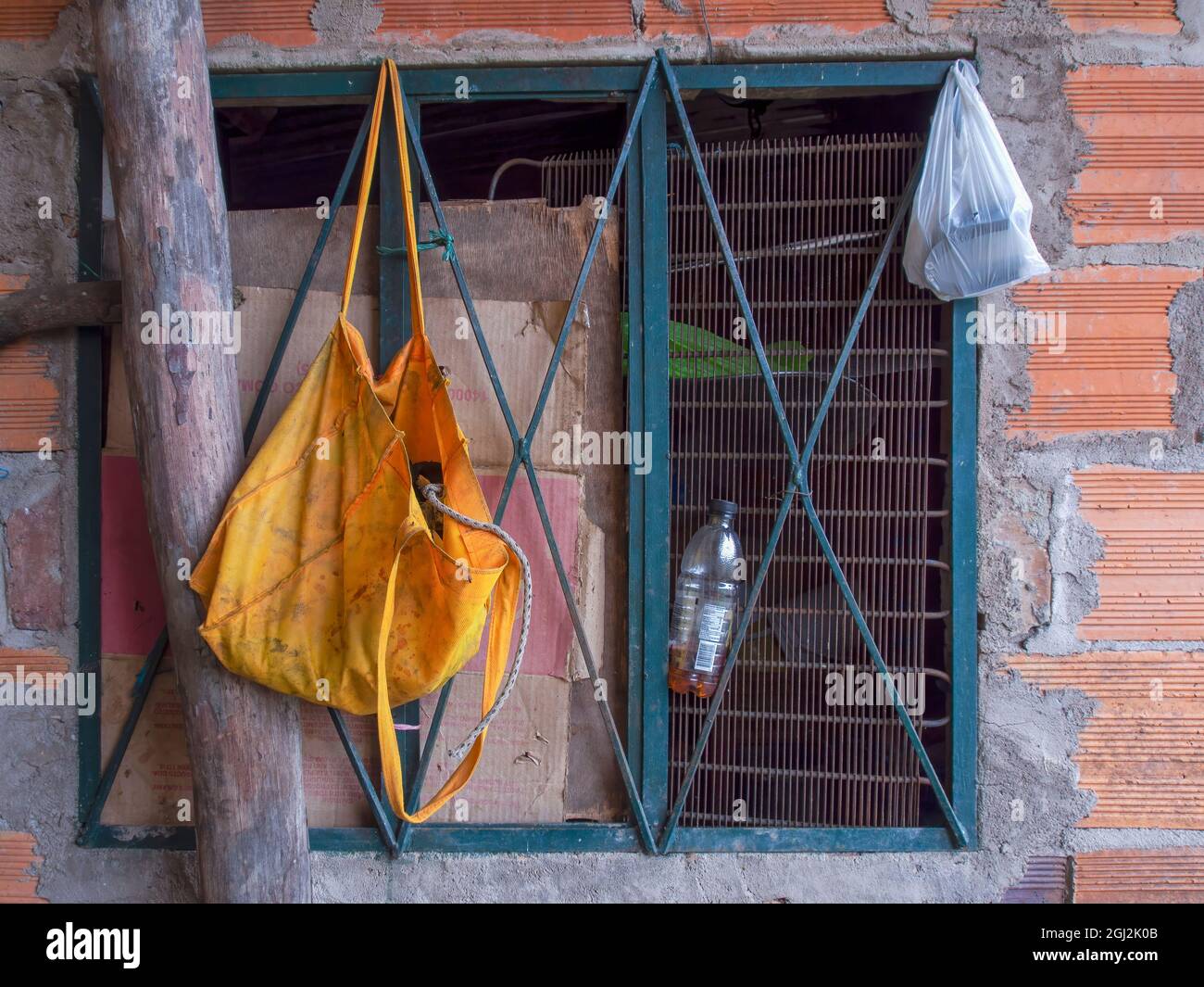 Different objects hanging in a window in a farm house near the town of ...