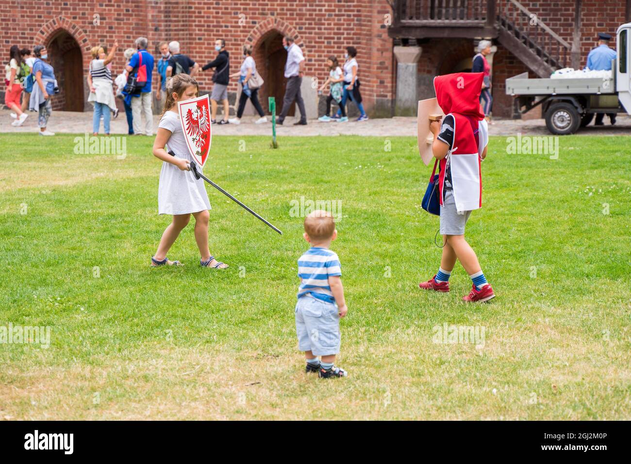 MALBORK, POLAND - Aug 28, 2021: Children with shields and swords ...