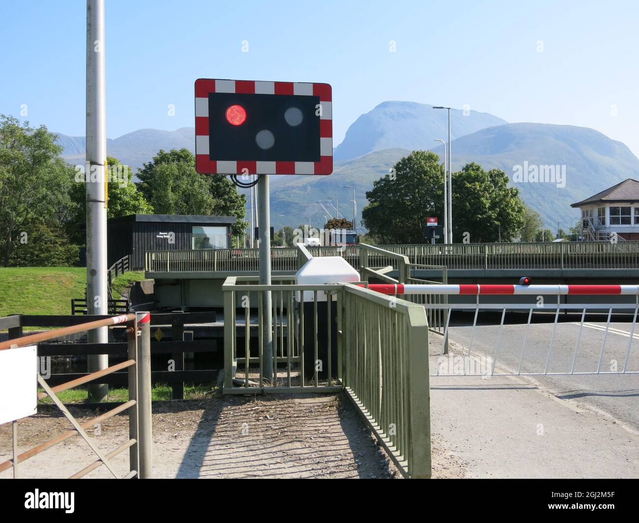 Red warning lights and barriers at the Banavie crossing where there's a ...