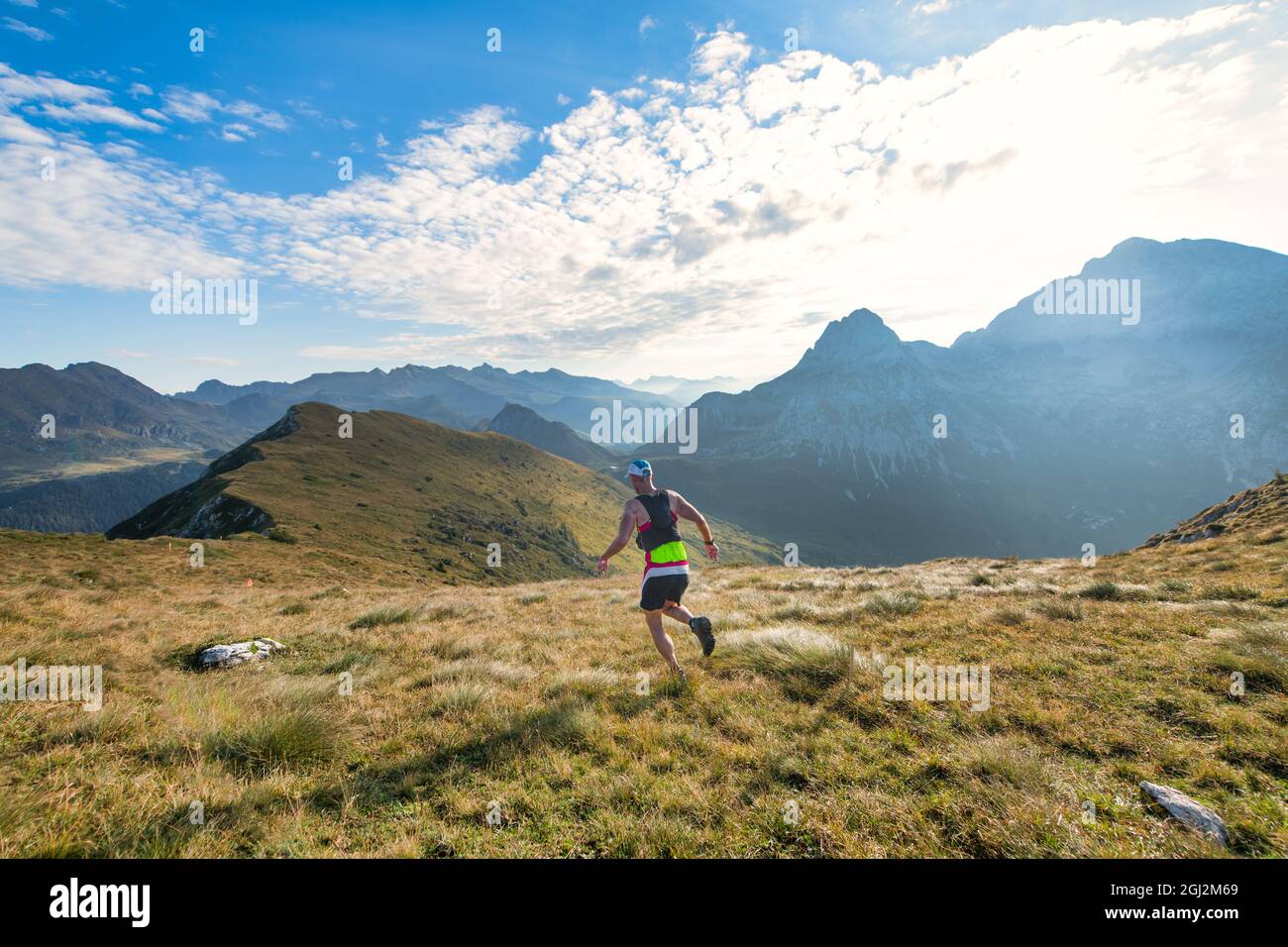 Ultra marathon mountain running race. an athlete downhill among the ...