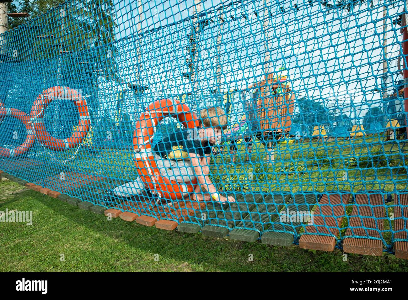 Seven year old boy playing at the playground Stock Photo - Alamy