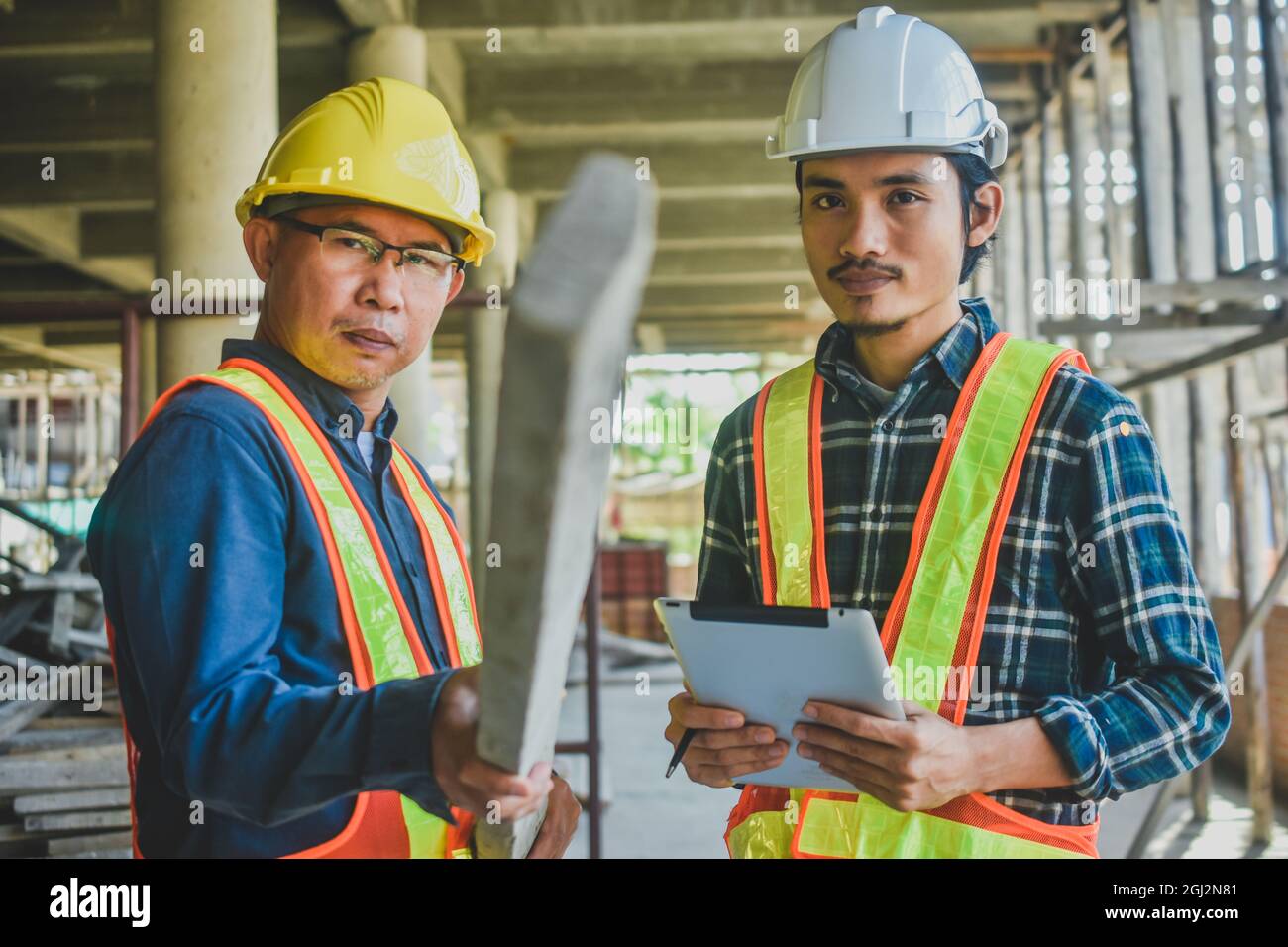 Two Engineer tablet inspection site construction real estate Stock Photo - Alamy