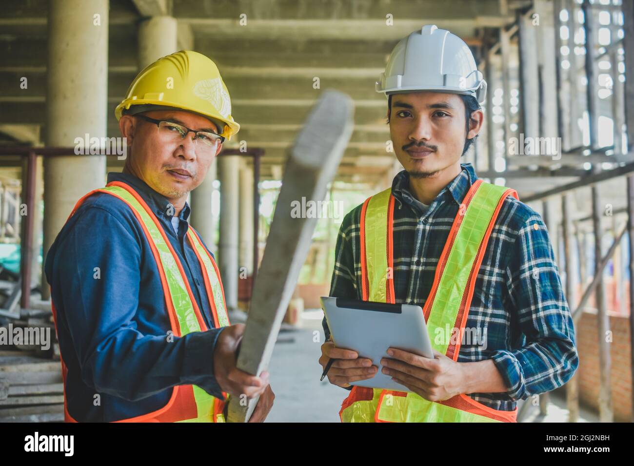Team work Engineer use tablet work on site construction Stock Photo - Alamy
