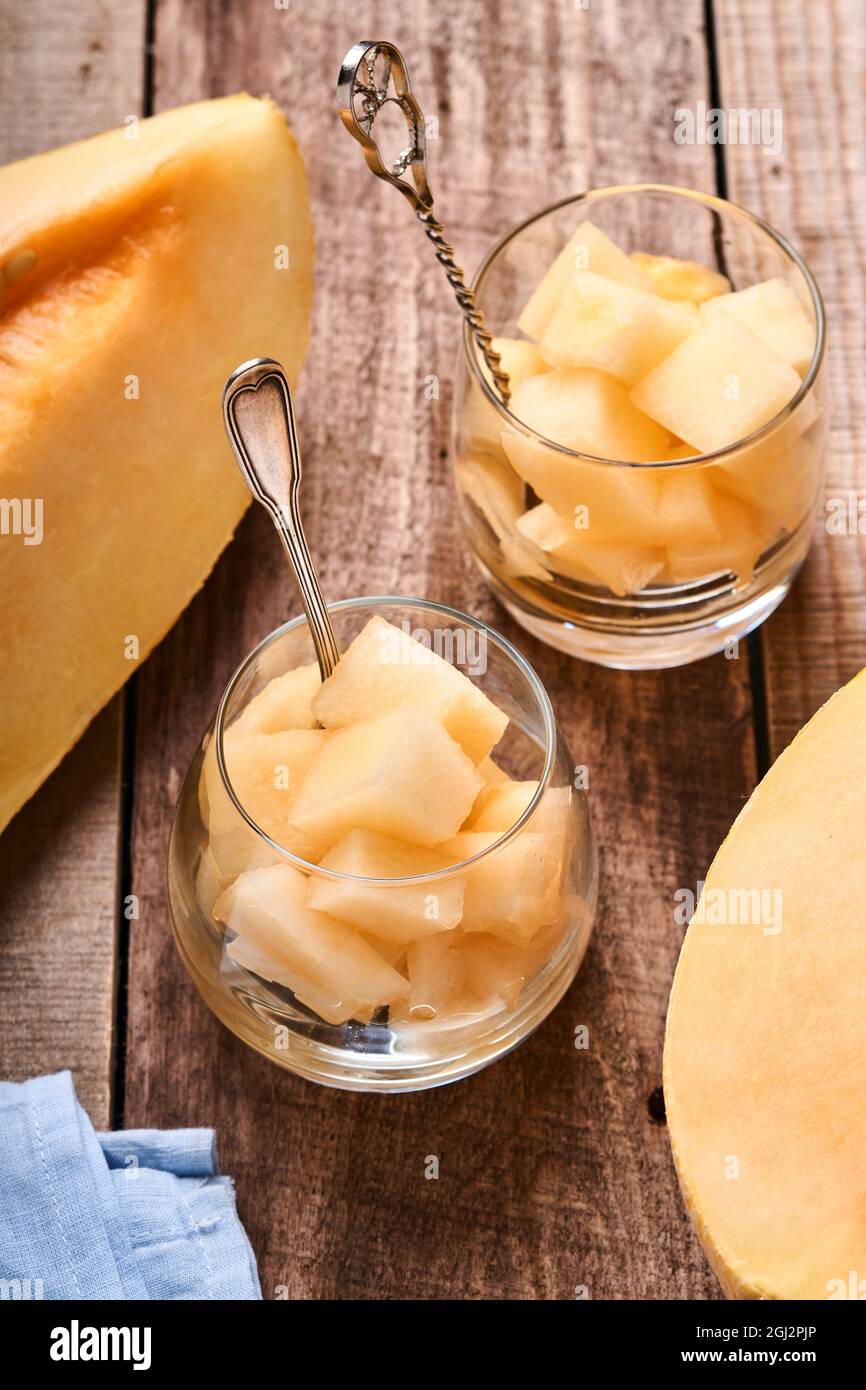 Melon. Pieces of fresh melon for making fruit dessert in glass on an ...