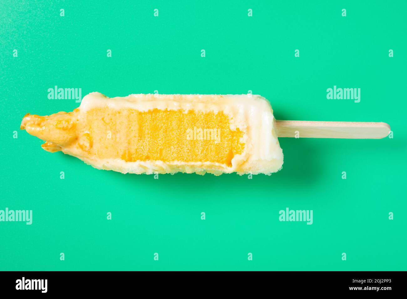 top view shredded pork popsicle with couple of bites on a green ...