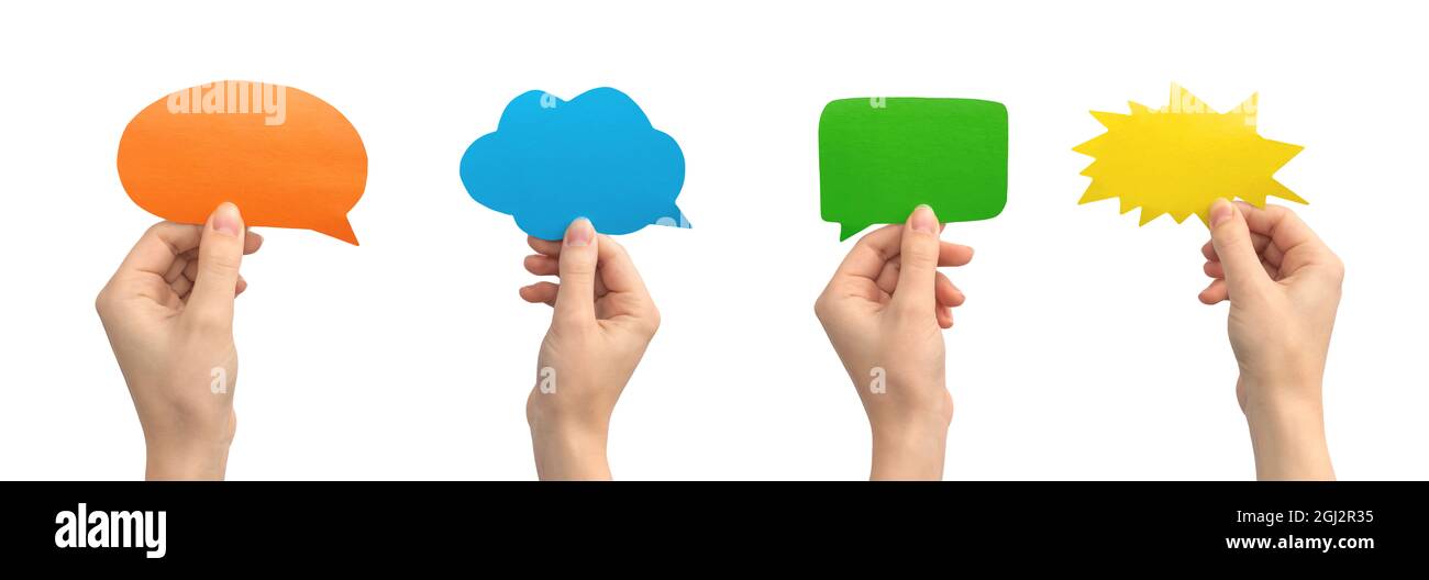 Group of multicolored speech bubbles in hands, empty cardboard and ...