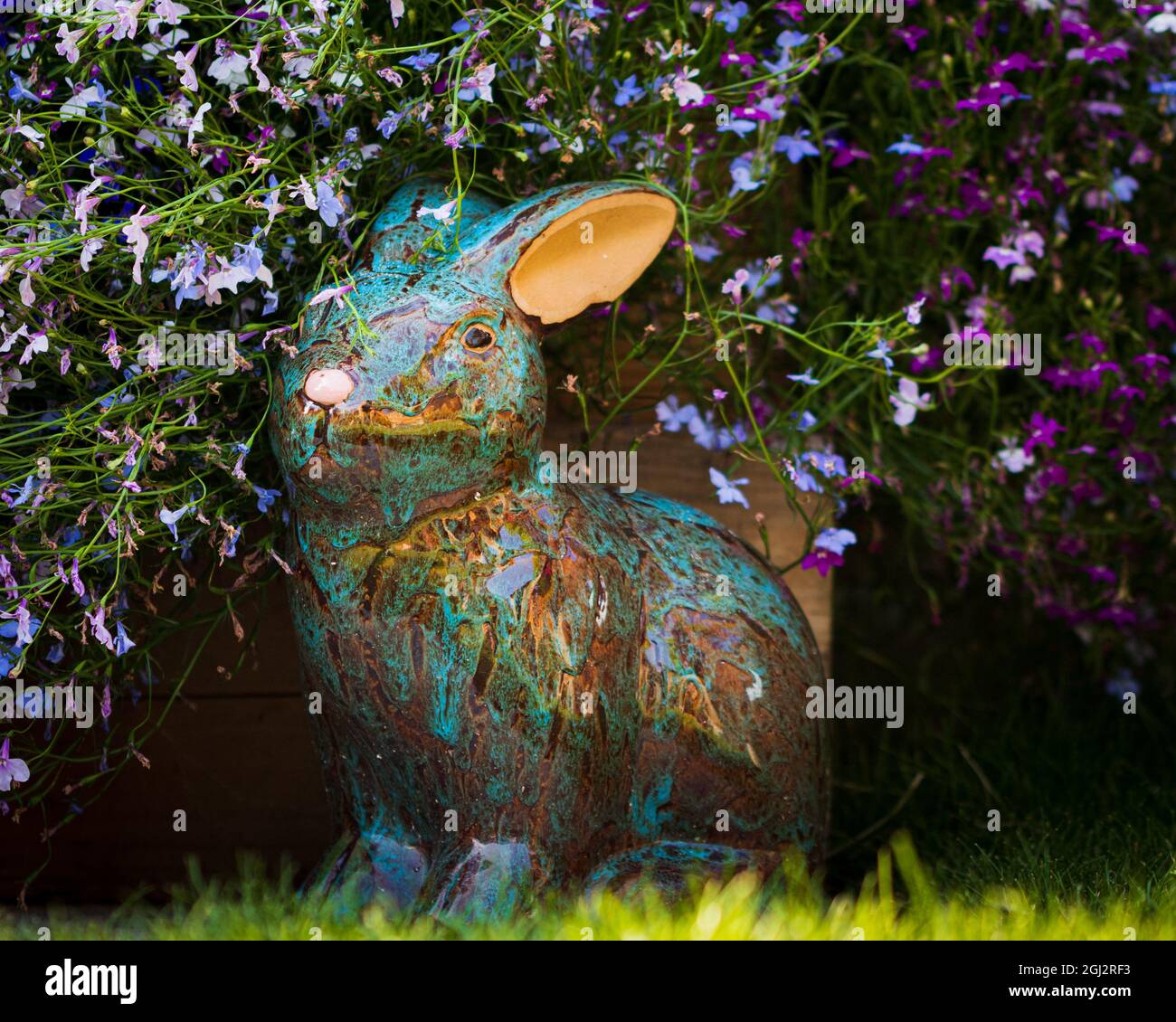Big stone sculpture of a rabbit between the trees Stock Photo - Alamy