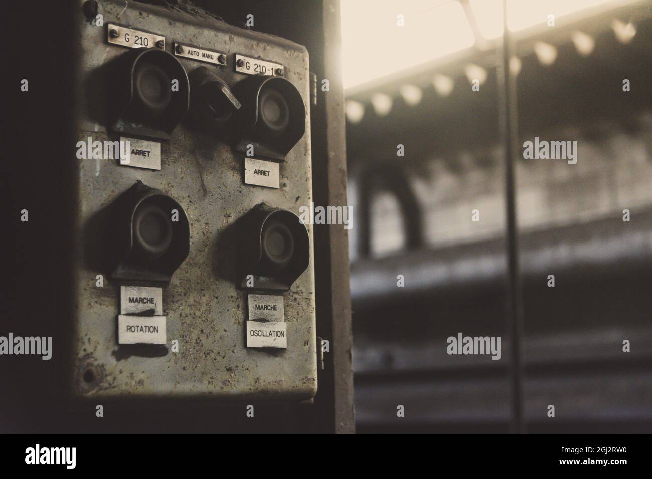 Close up shot of a rusty control panel has four of push buttons and one ...