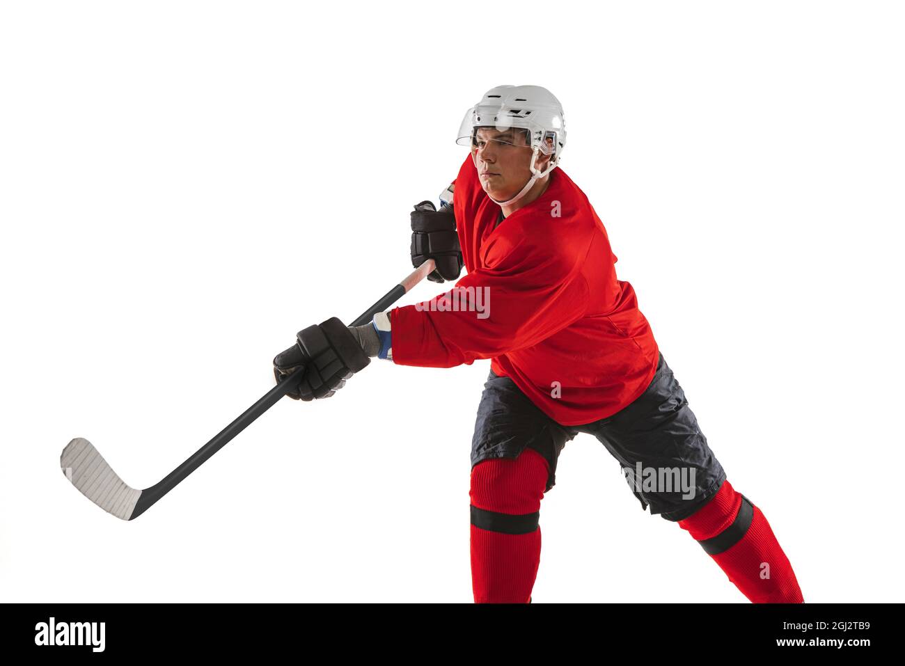 Portrait of professional male hockey player training isolated over ...