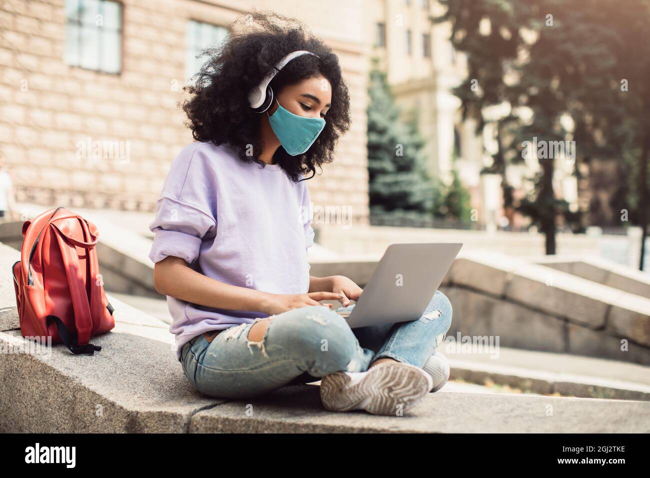 African Female Student Browsing Internet On Laptop Computer Wearing ...