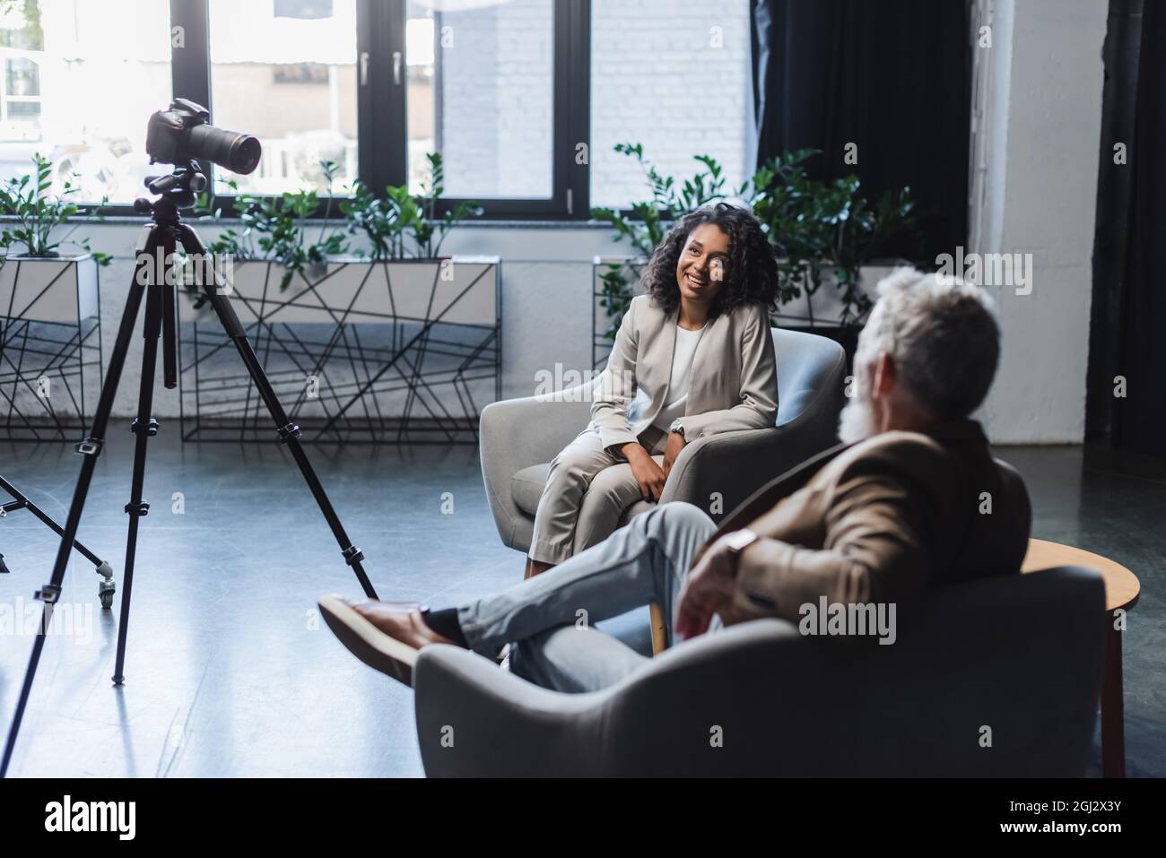 happy african american journalist and blurred businessman talking ...