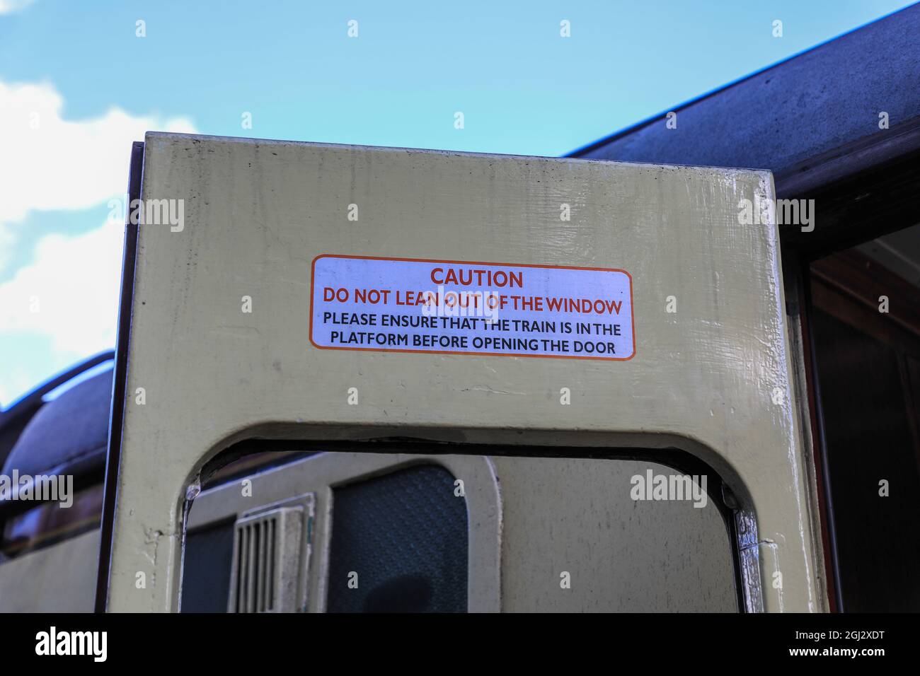 A sign on the door of a railway carriage saying 'do not lean out of the ...