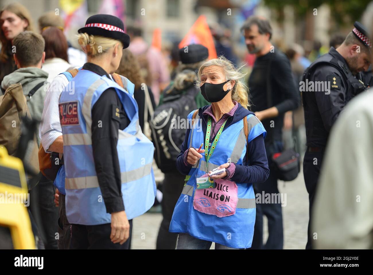 London, England, UK. Police liaison officer with a protest organiser at ...