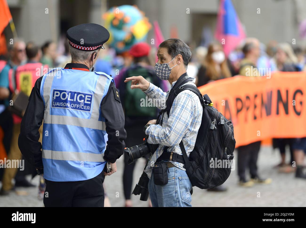 London, England, UK. Police liaison officer with a photographer at a ...