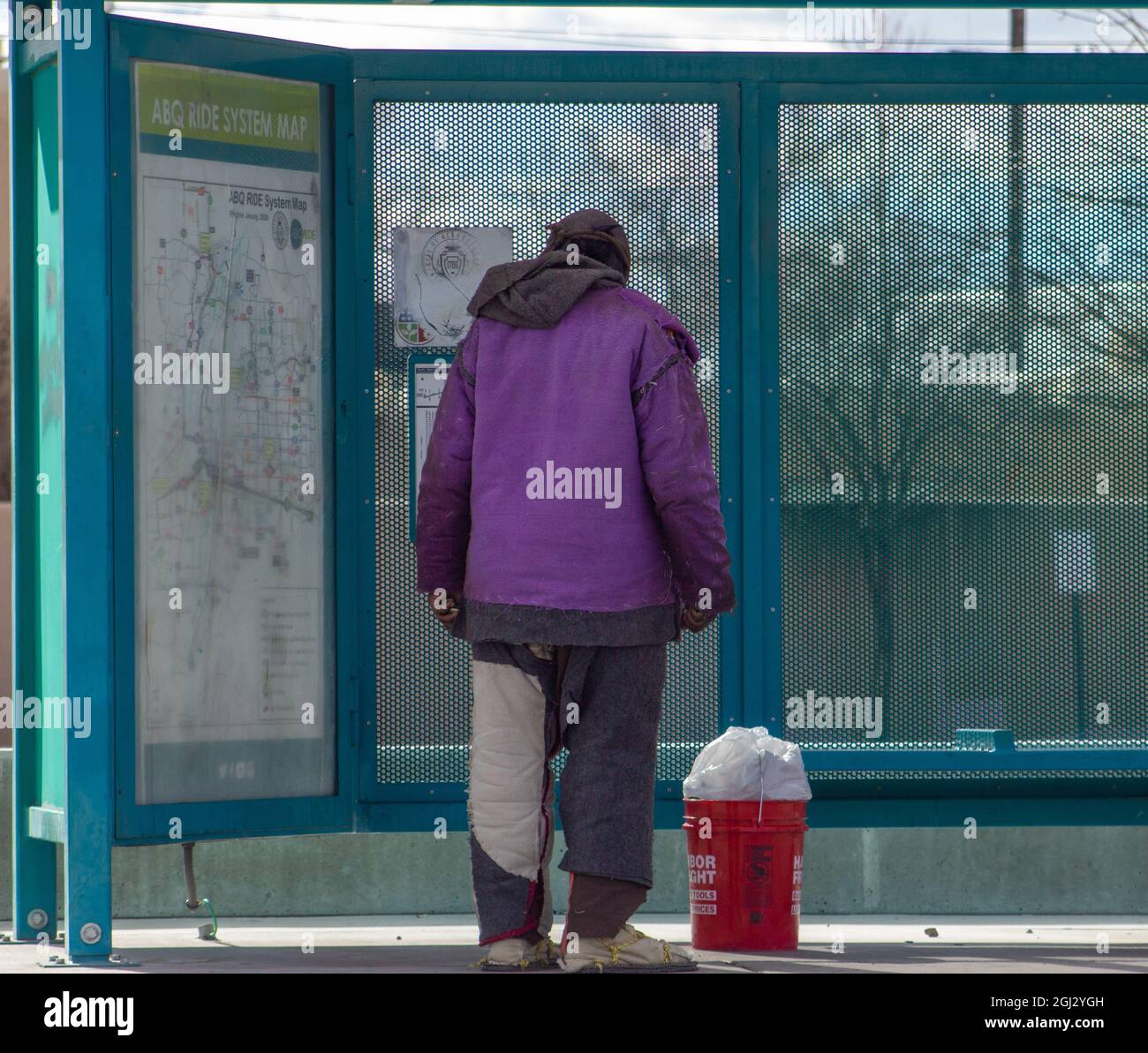 Homeless Man at Bus Stop Stock Photo - Alamy