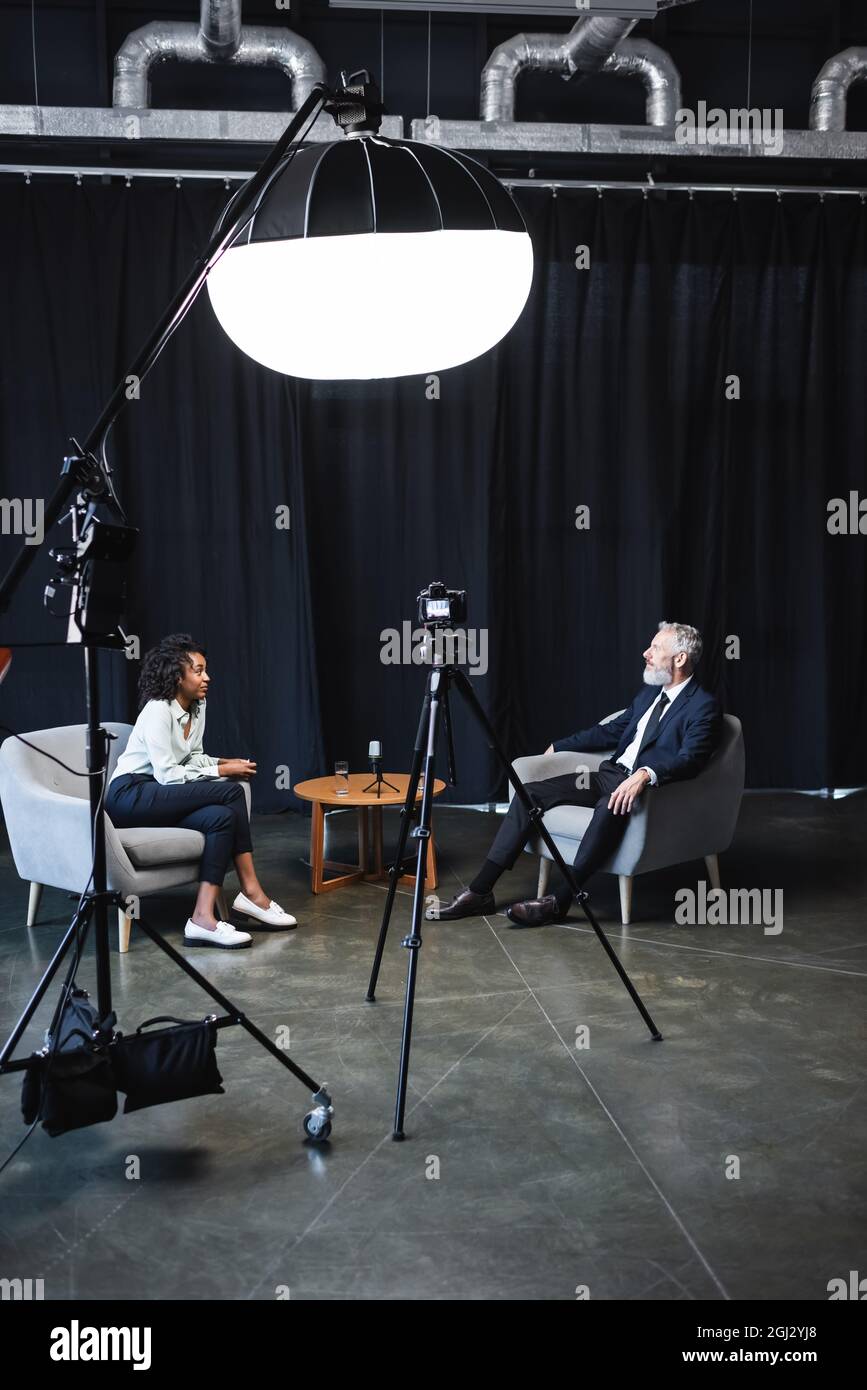african american journalist talking with businessman in interview ...