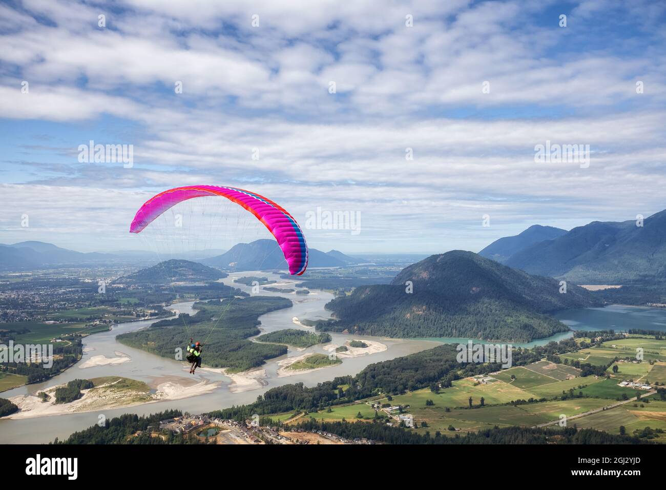 Adventurous people Paragliding around the Canadian mountains Stock ...