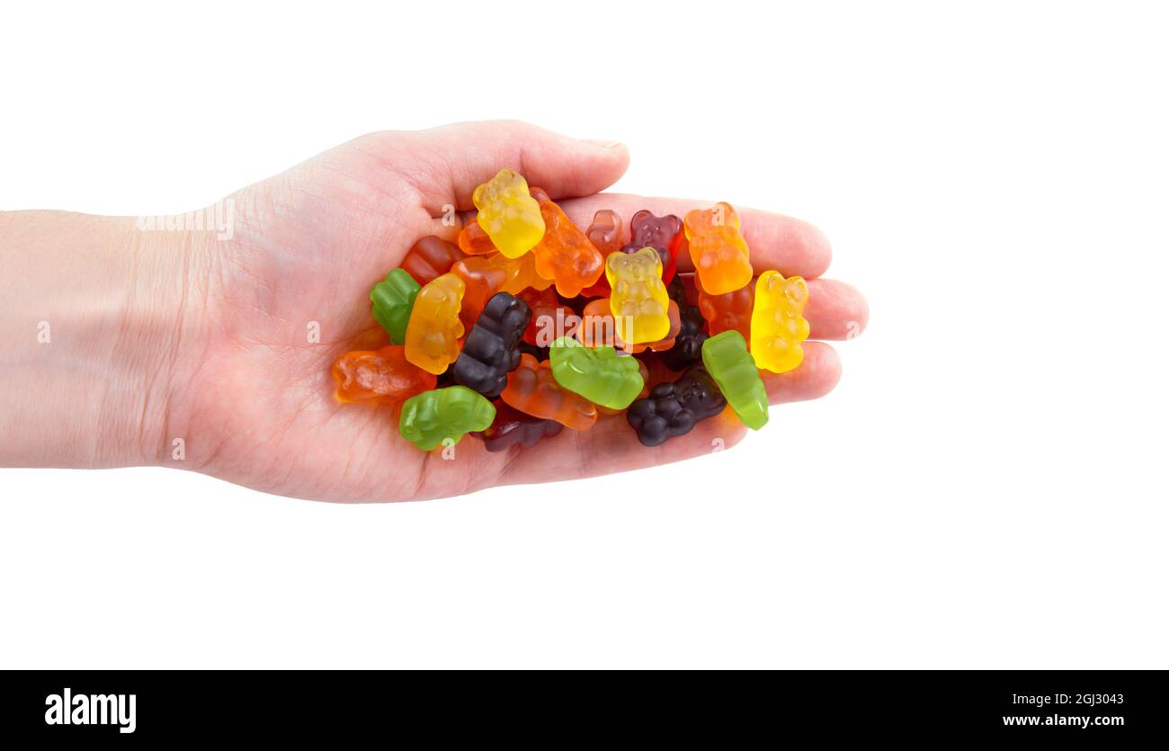 Closeup of a human hand full of multicolored gummy bears isolated on ...