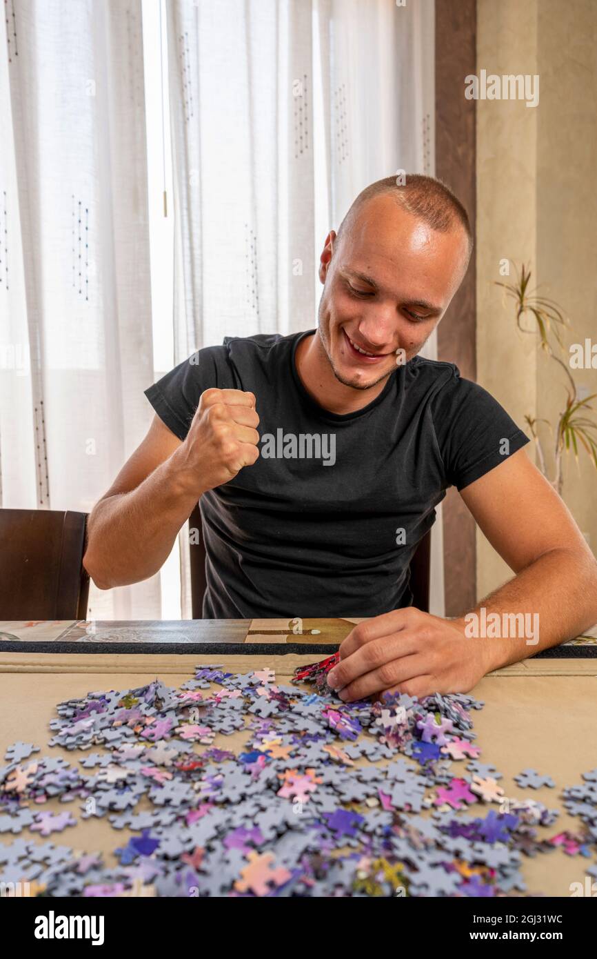 Young people doing jigsaw puzzle hi-res stock photography and images ...